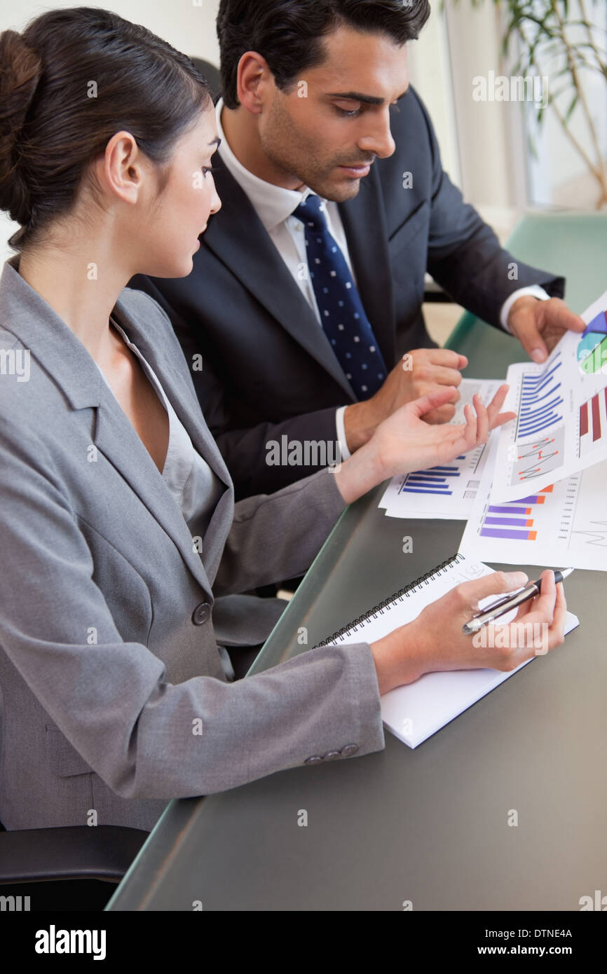 Portrait of sales persons studying graphs Stock Photo - Alamy