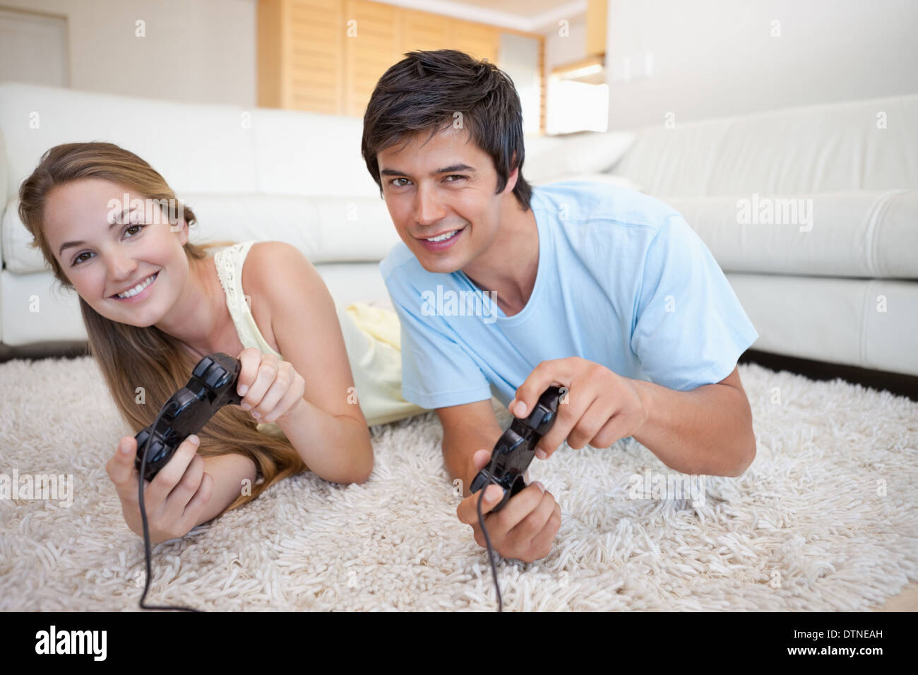 Happy couple playing video games Stock Photo - Alamy
