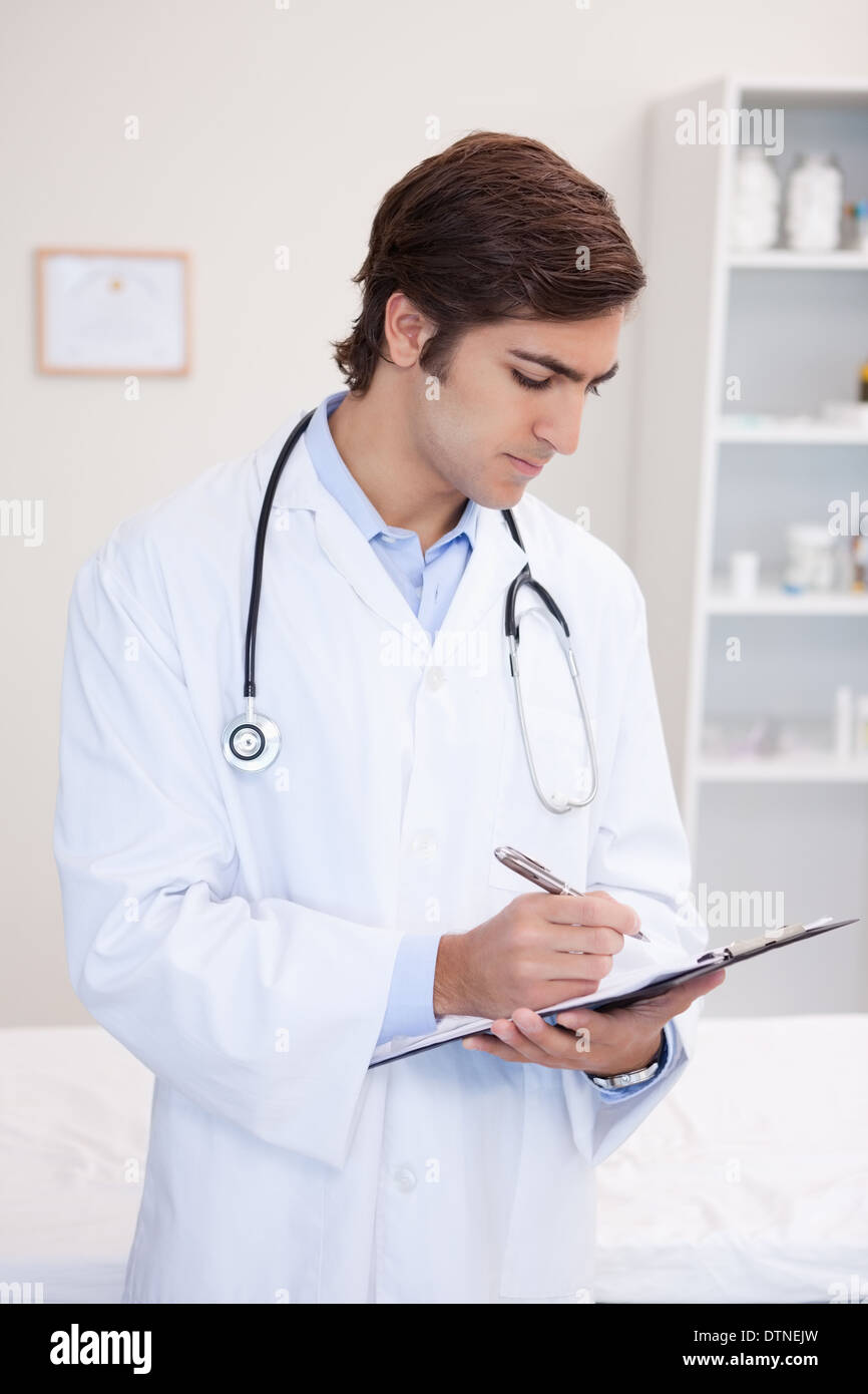 Male doctor taking notes Stock Photo - Alamy