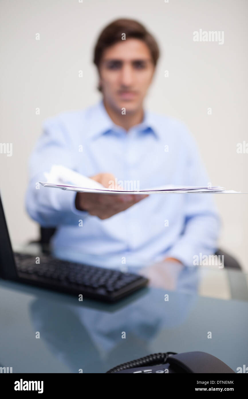 Paperwork being handed over by businessman Stock Photo - Alamy