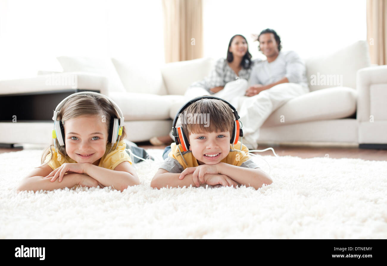 Cute siblings listening music with headphones Stock Photo - Alamy