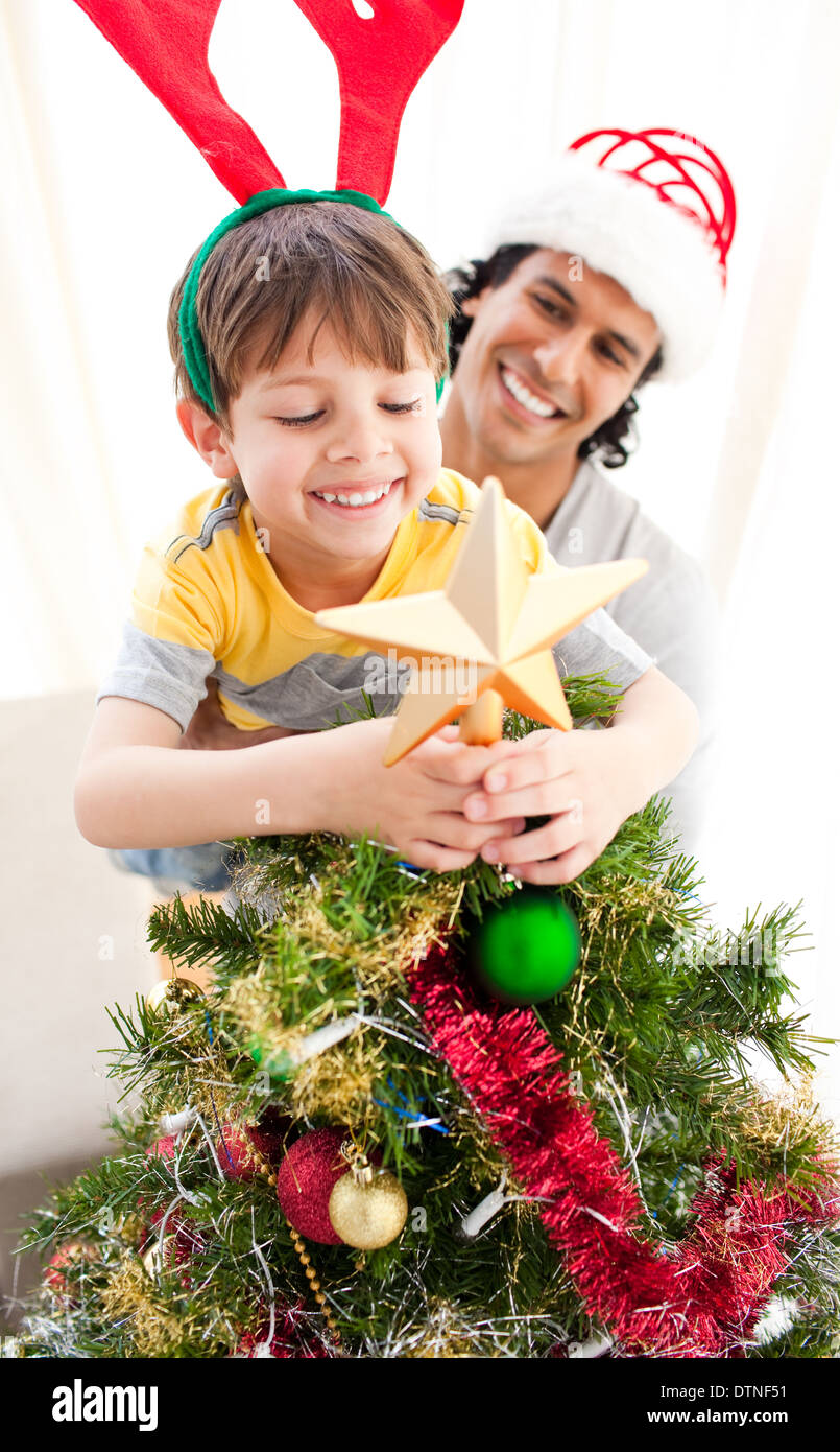 Father and son decorating a Christmas tree Stock Photo - Alamy