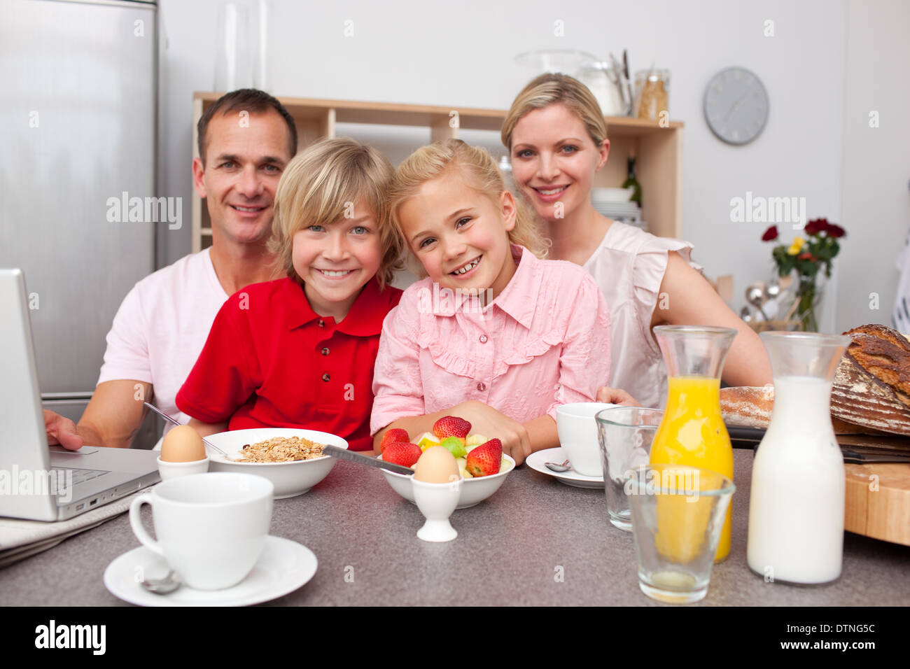 Happy family having breakfast together Stock Photo - Alamy