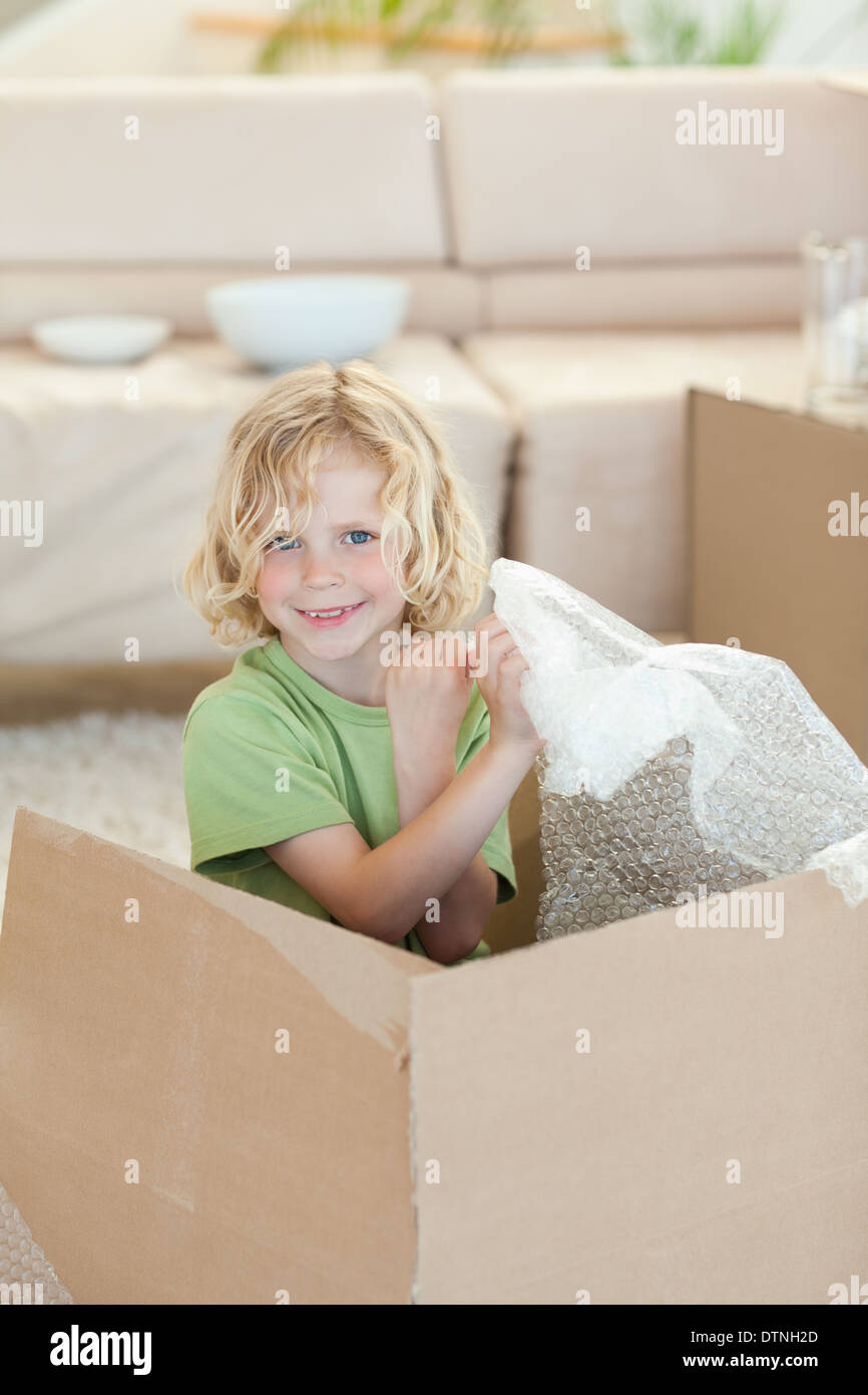 Boy playing with cardboard box Stock Photo - Alamy
