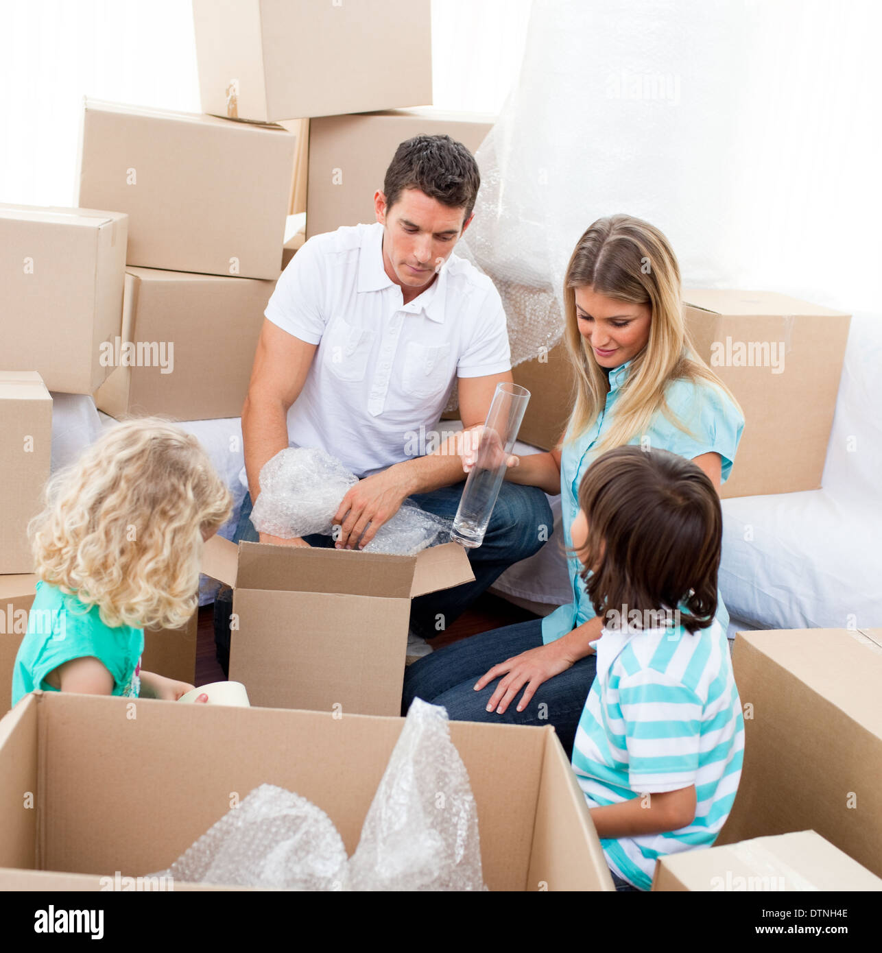 Positive family packing boxes Stock Photo - Alamy