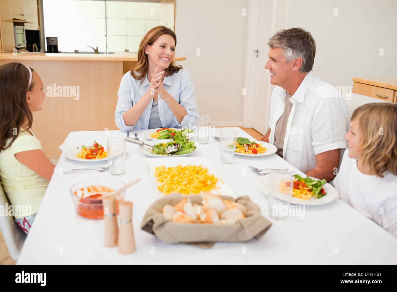 Happy family at the dinner table Stock Photo - Alamy