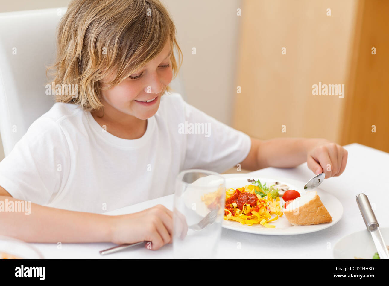 Boy eating dinner Stock Photo - Alamy