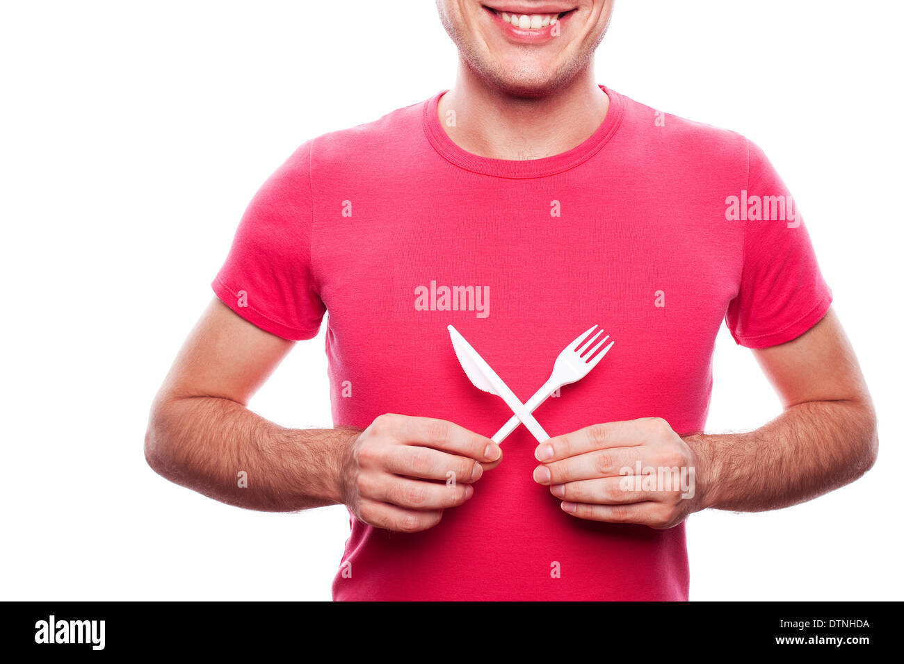 smiling handsome guy holding plastic fork and knife near his stomach ...