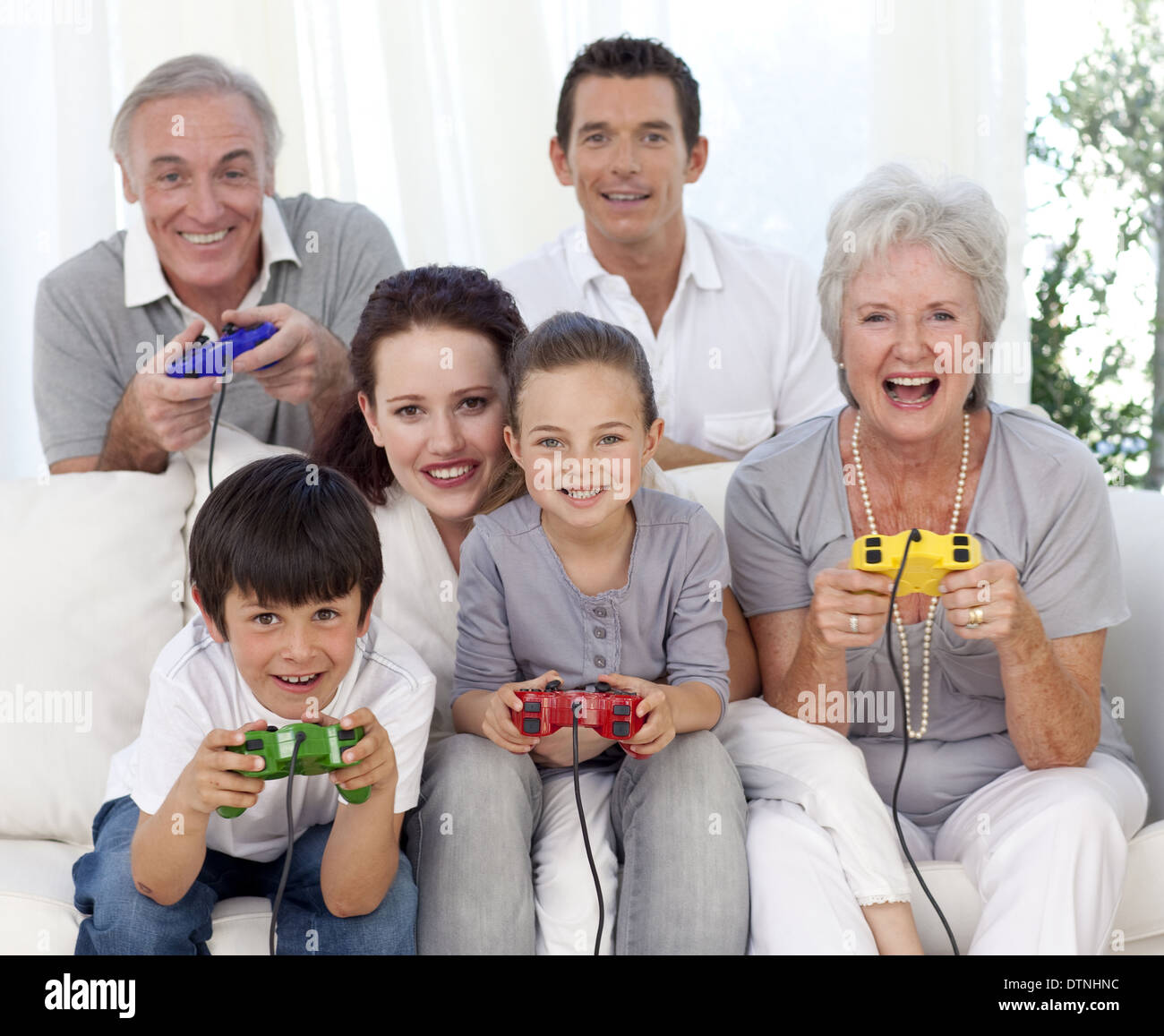 Family playing video games at home Stock Photo - Alamy