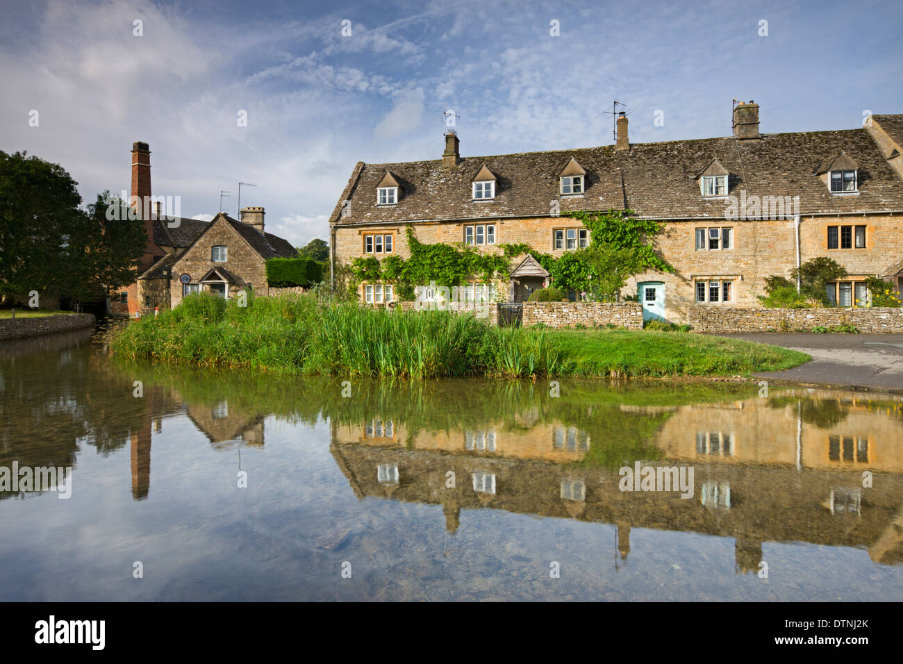 Cottages and footbridge over the River Eye in the Cotswolds village of ...