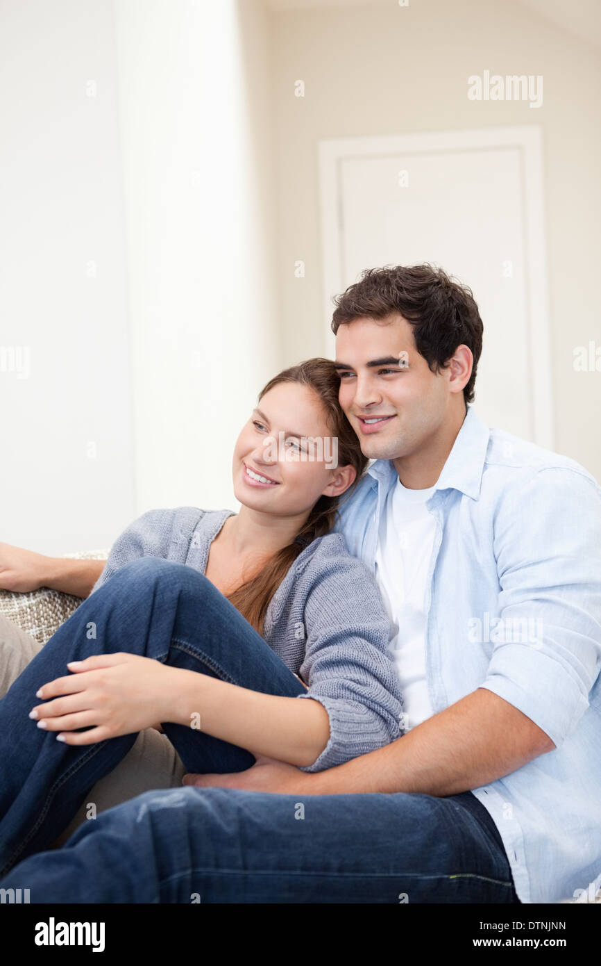 Couple sitting while embracing each other Stock Photo - Alamy