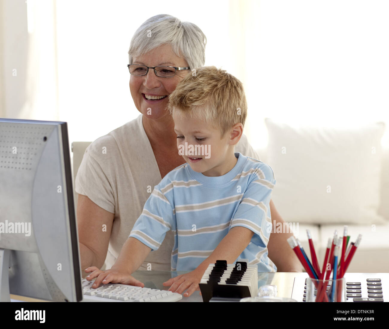 Grandson and grandmother using a computer Stock Photo - Alamy