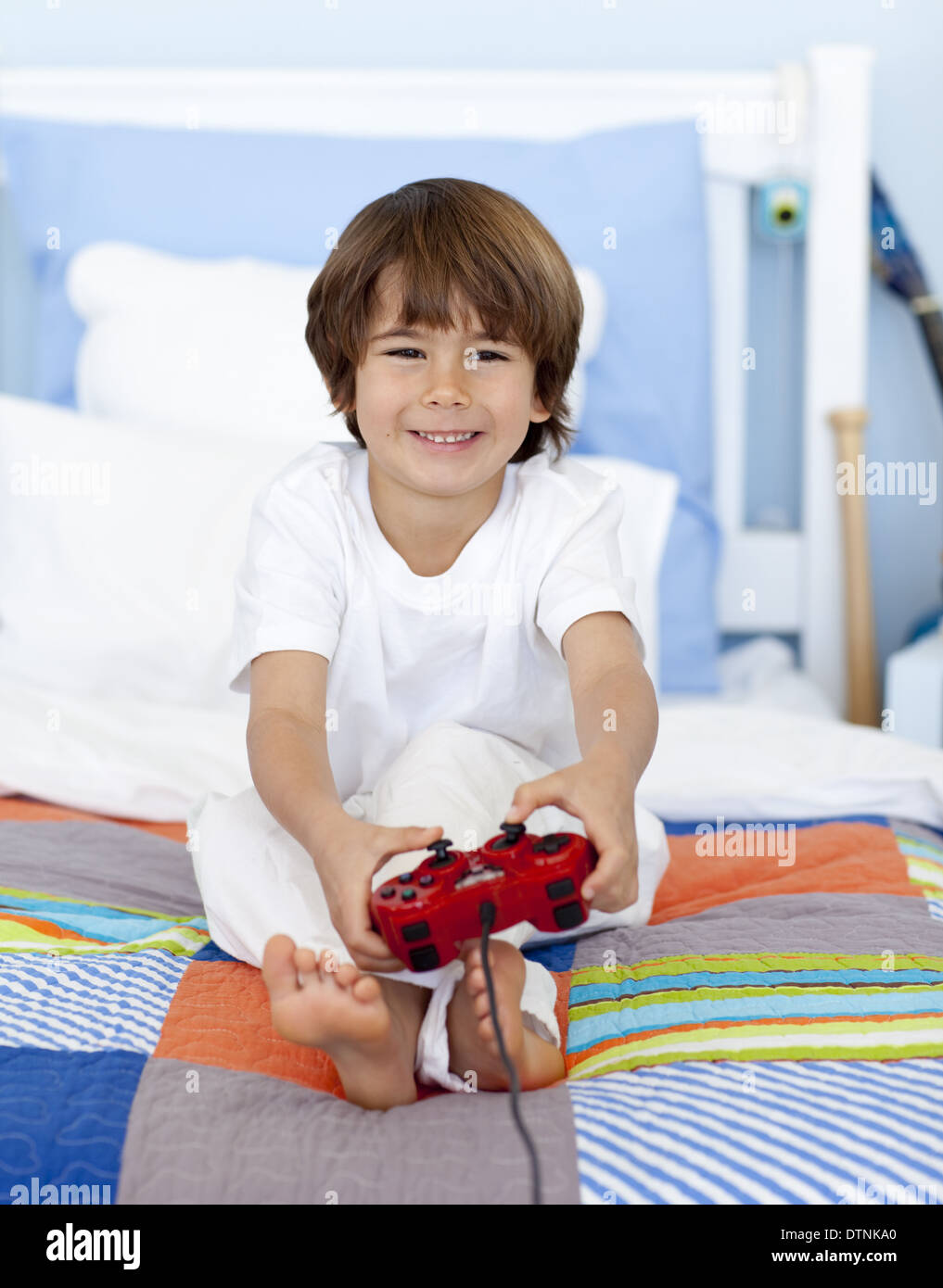Boy playing videogames sitting in hi-res stock photography and images ...