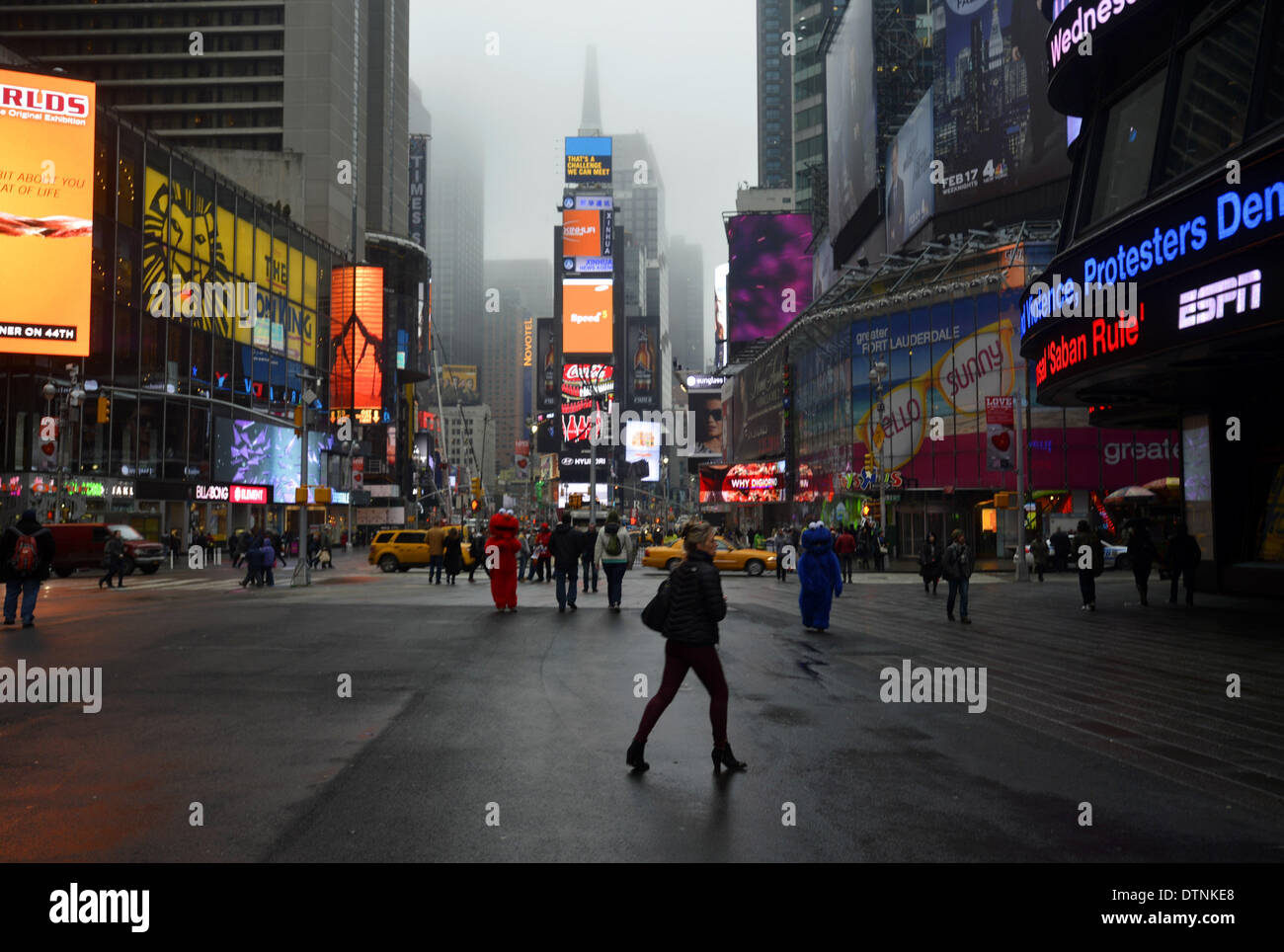 New York, USA. 21st Feb, 2014. A woman walks in fog at Times Square in ...