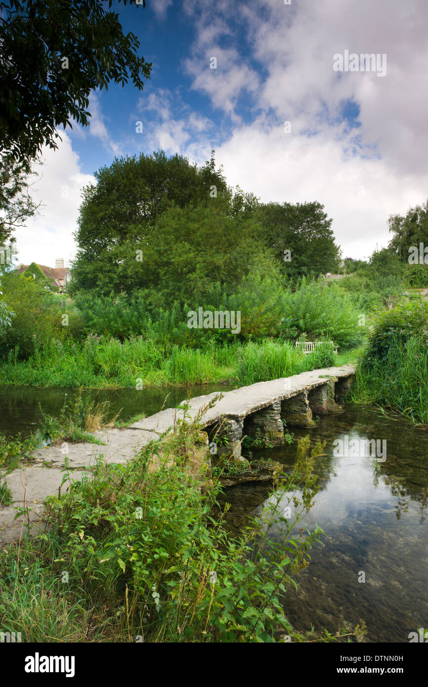 Stone clapper bridge over the River Leach at Eastleach Turville in the ...