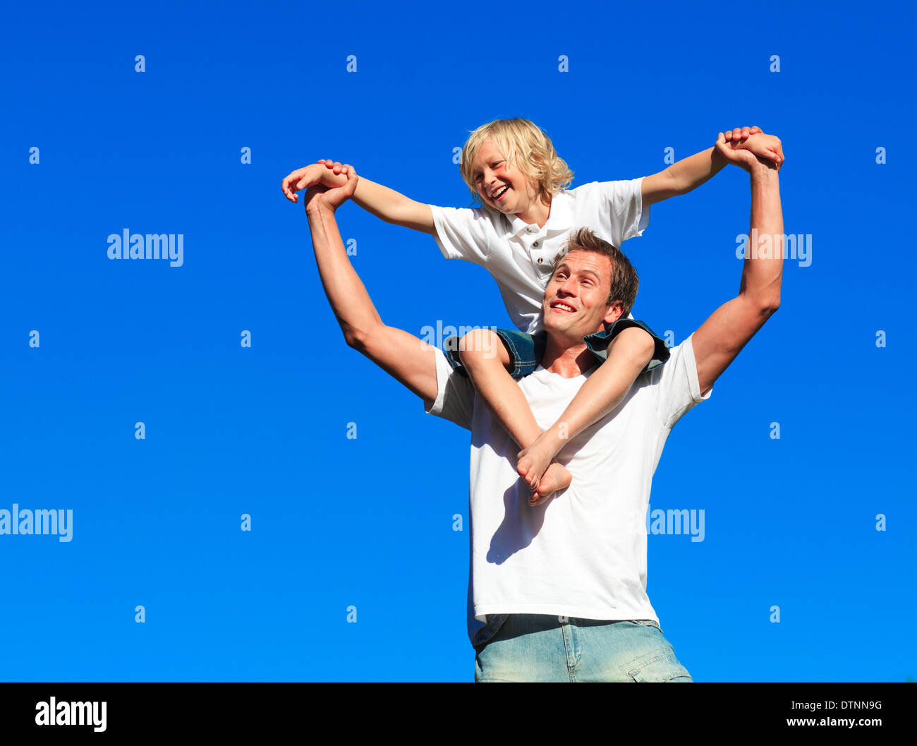 Boy giving kid a piggyback ride Stock Photo - Alamy