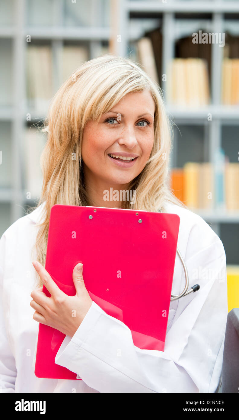 Nurse holding a pink folder Stock Photo - Alamy