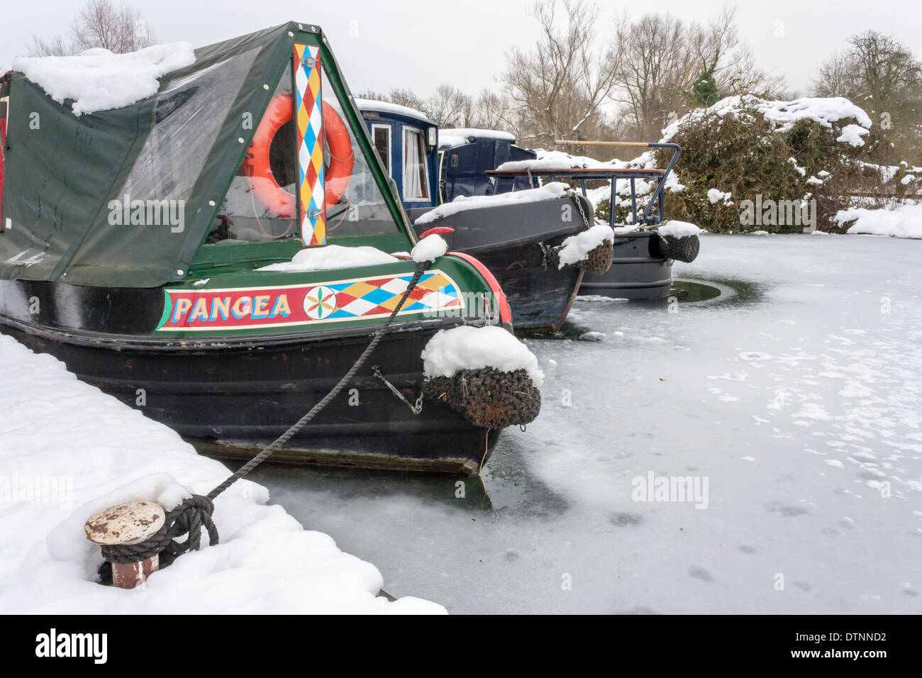 Canal boats moored together in icy water. Kennet and Avon Canal ...