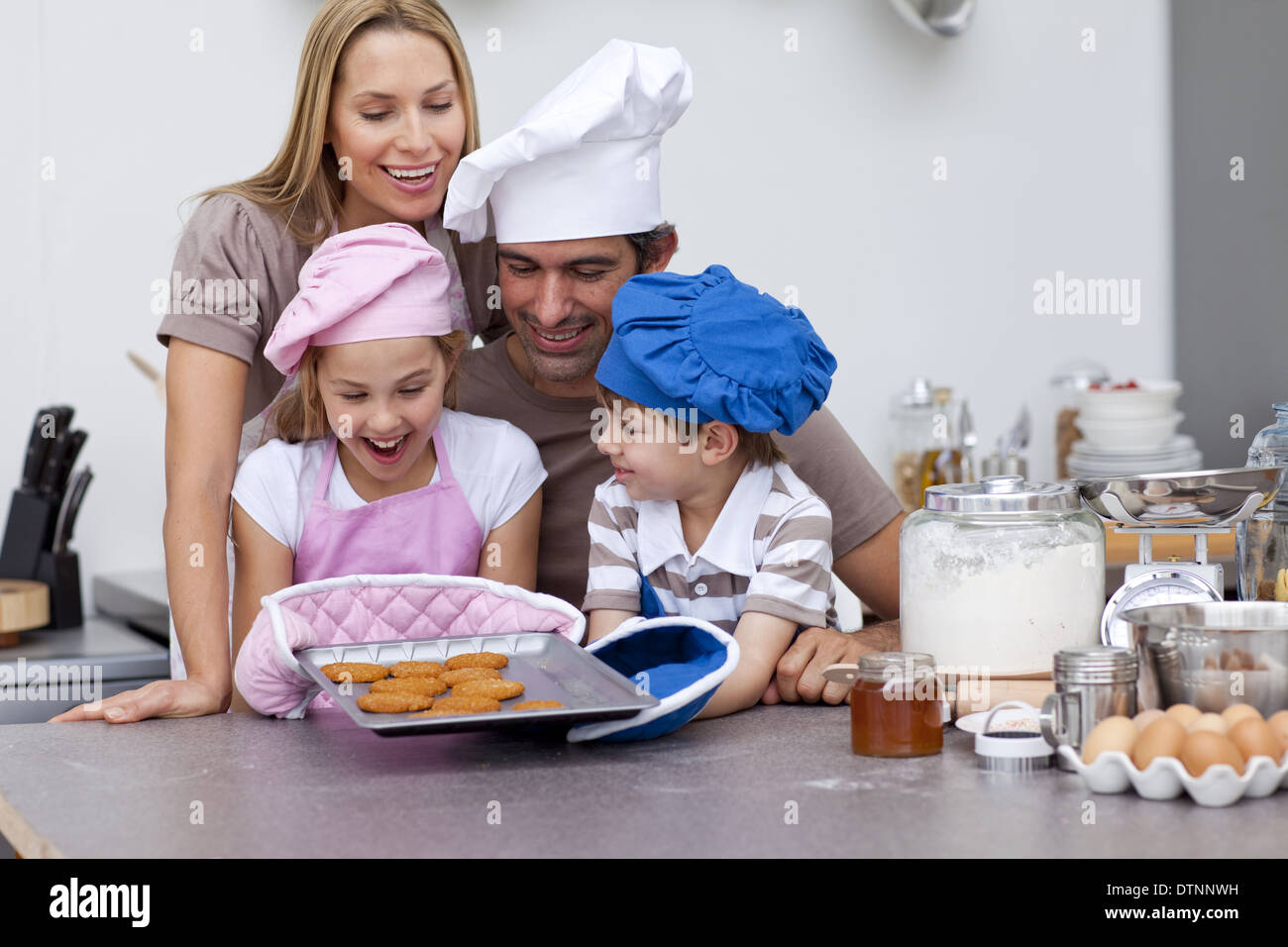 Happy family baking cookies in the kitchen Stock Photo - Alamy