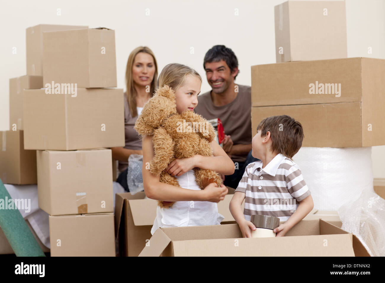 Family moving house playing with boxes Stock Photo - Alamy