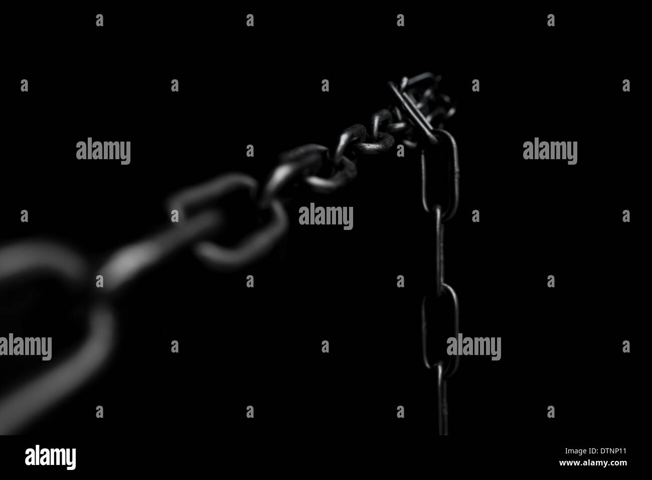 Metallic chain with black background Stock Photo - Alamy