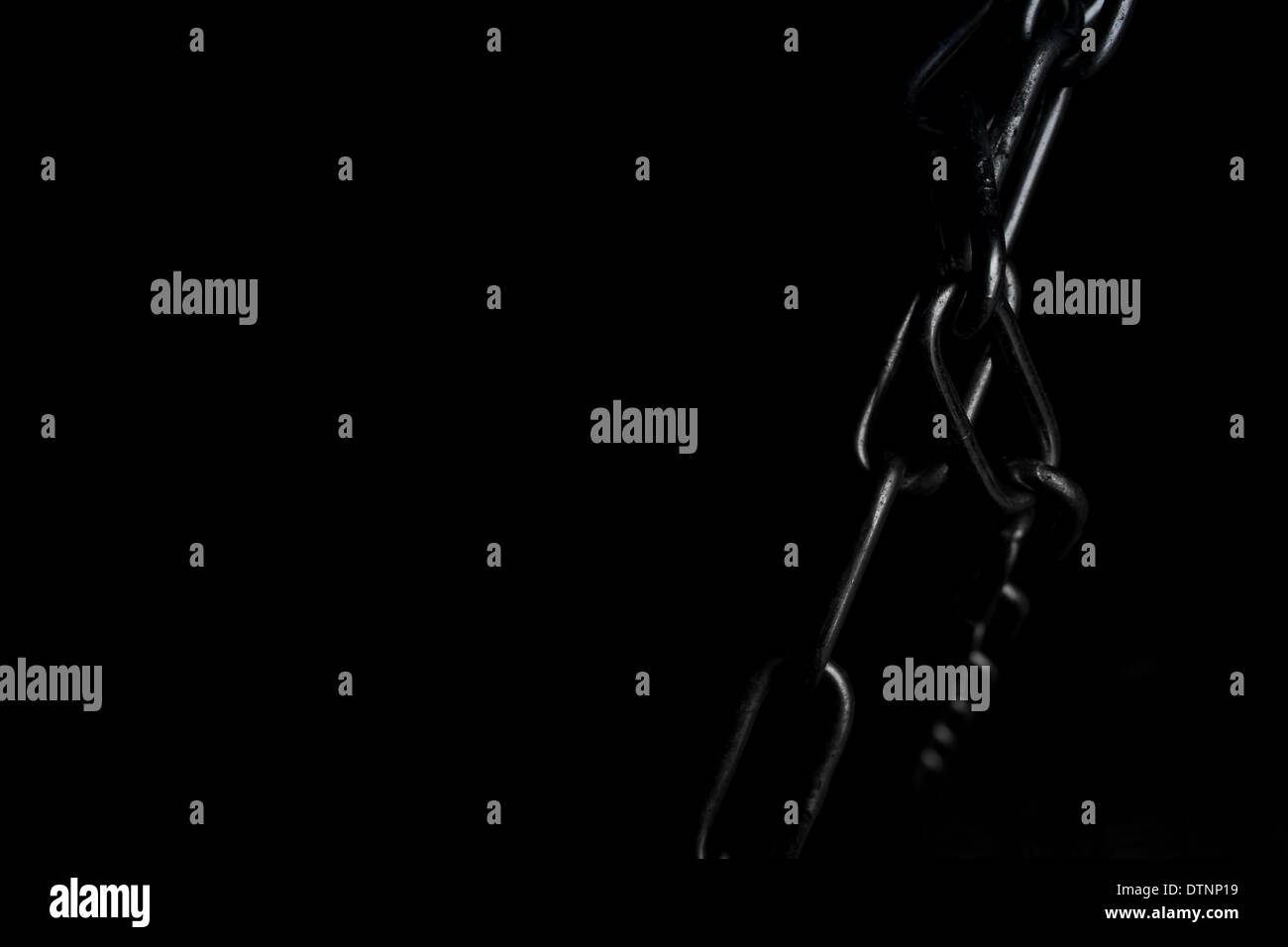 Metallic chain with black background Stock Photo - Alamy