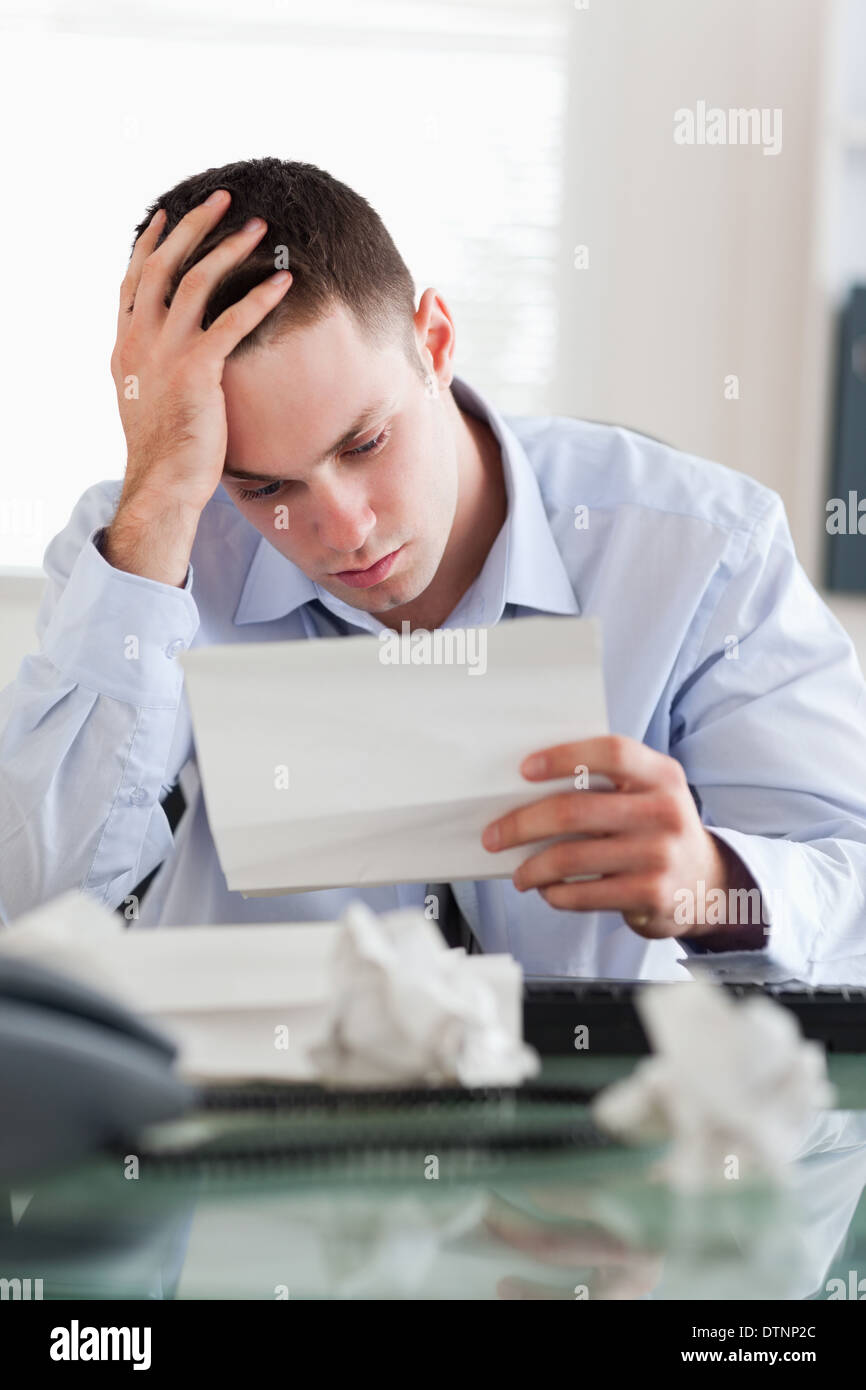 Businessman reading a bill Stock Photo - Alamy