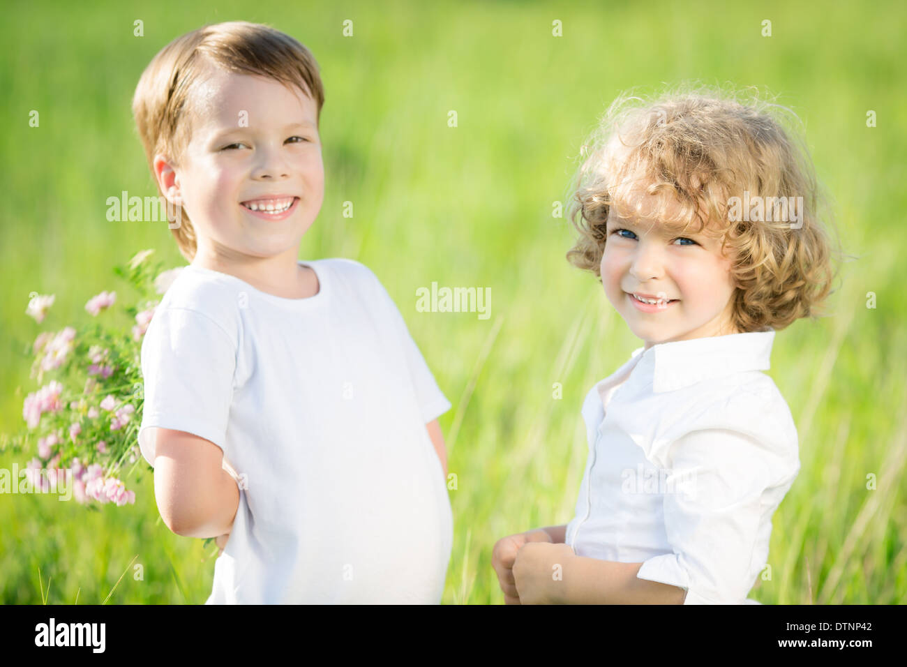 Happy children with flowers Stock Photo - Alamy