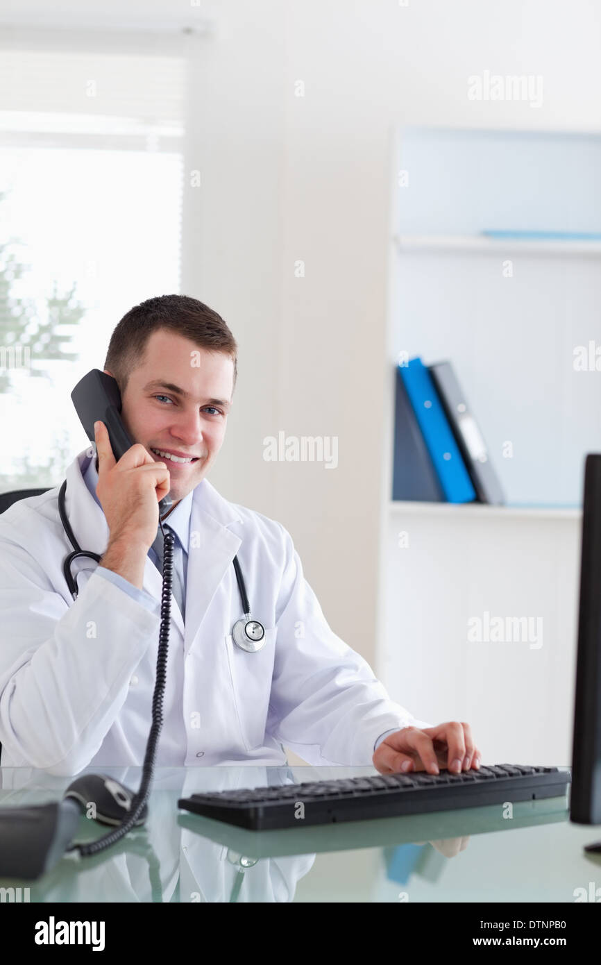Doctor talking with patient on the telephone Stock Photo - Alamy