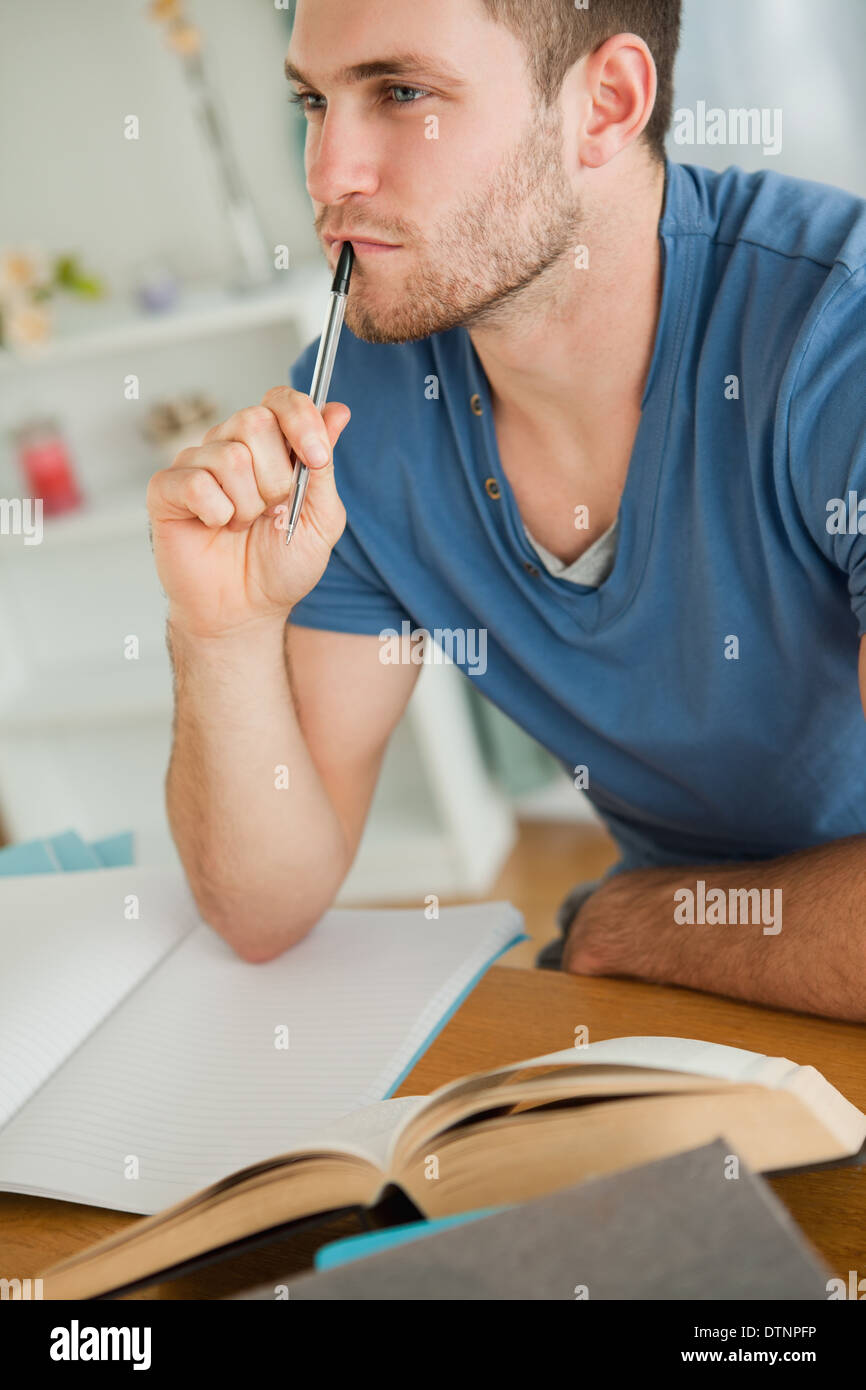 Student thinking about his book report Stock Photo - Alamy