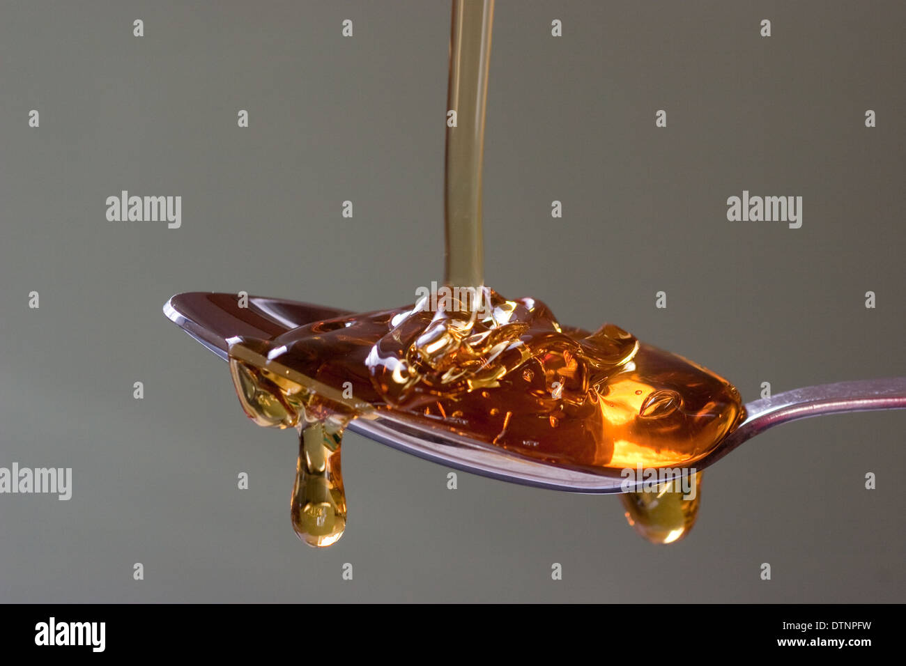 Syrup pouring into spoon hi-res stock photography and images - Alamy