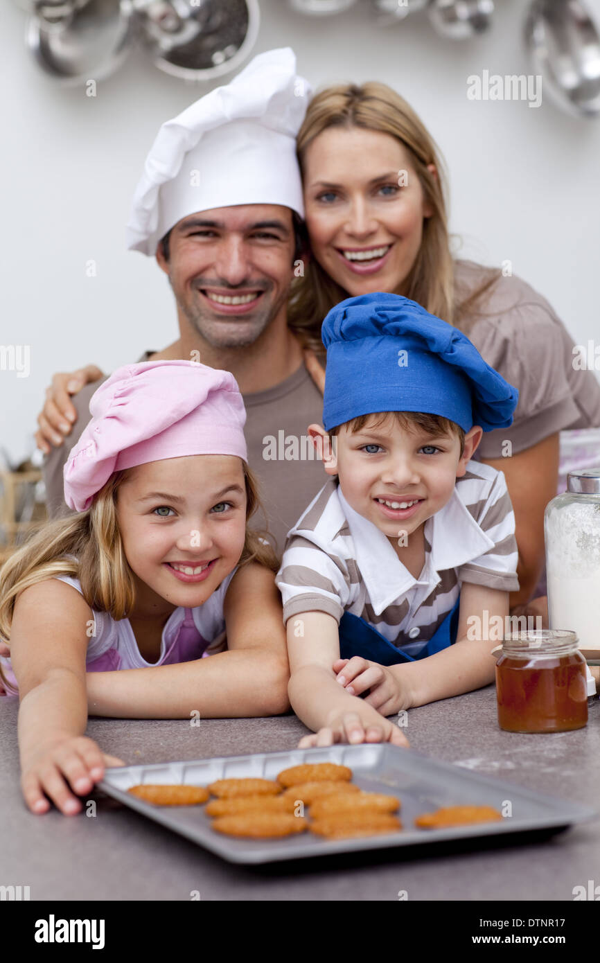 Happy children and parents eating biscuits Stock Photo - Alamy