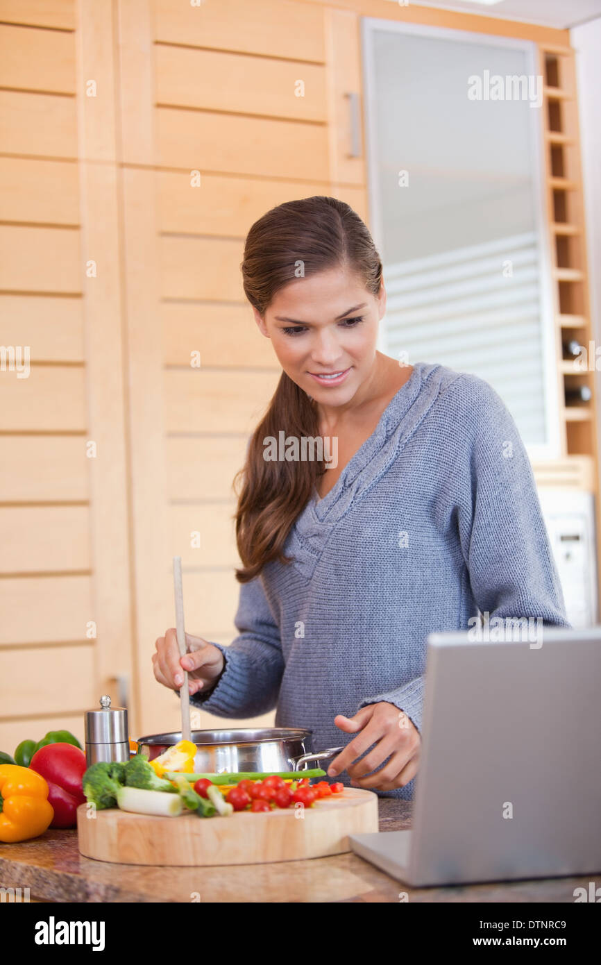 Woman reading off a recipe while cooking Stock Photo - Alamy