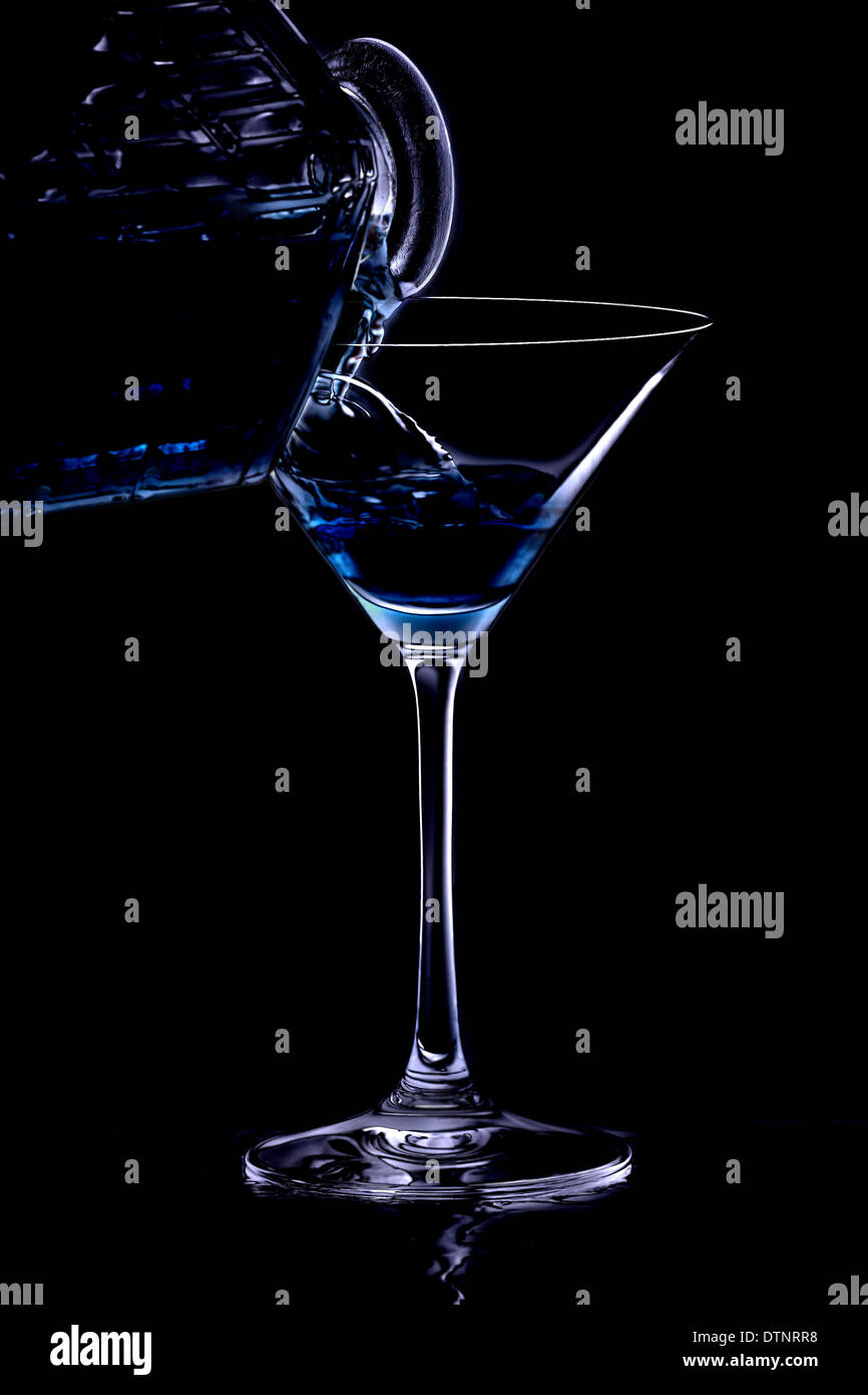 Pouring a drink in the night Stock Photo - Alamy