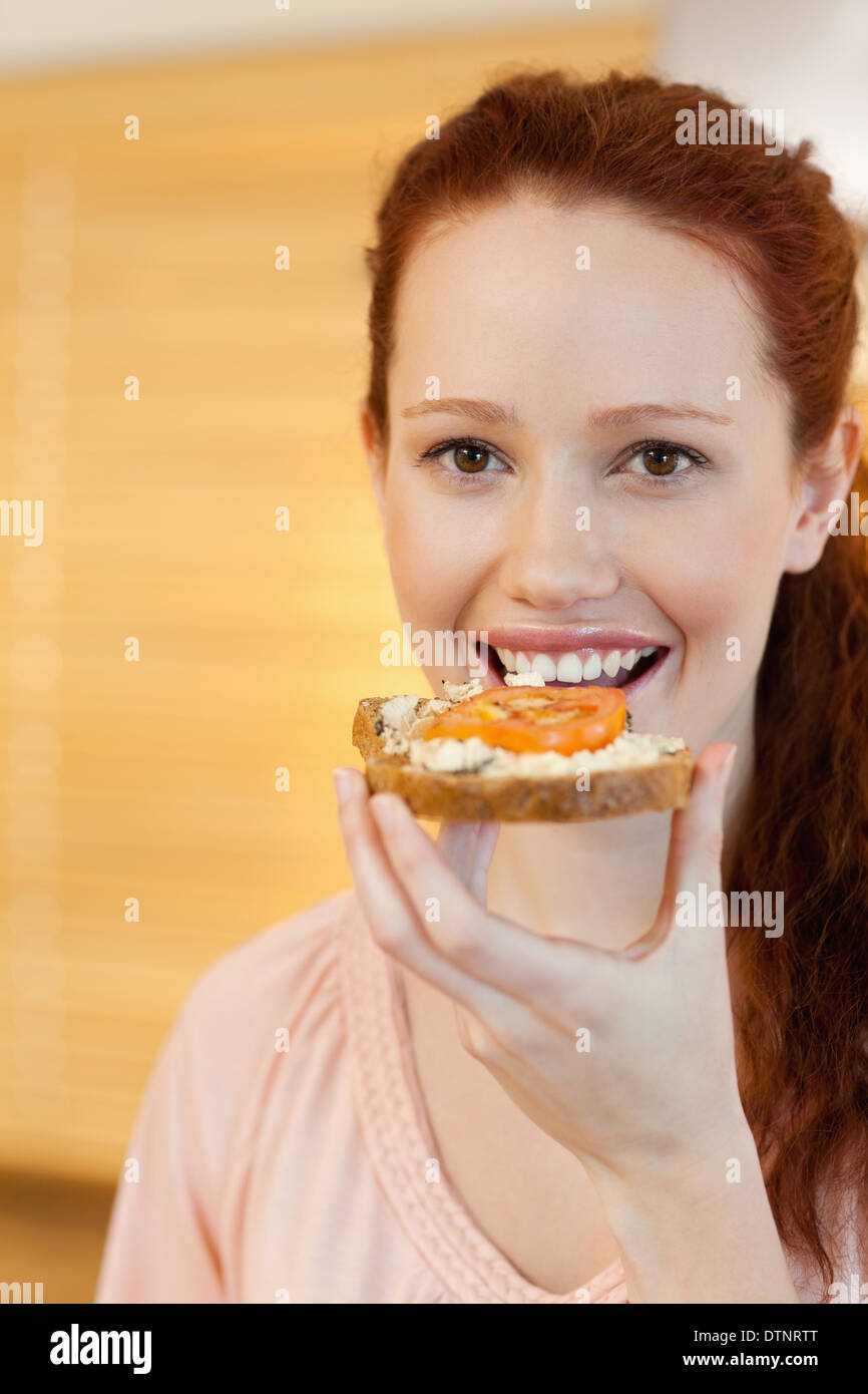 Woman having a slice of bread Stock Photo - Alamy