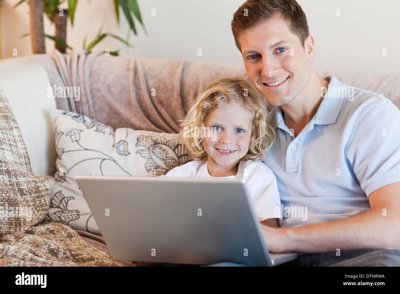 Father and son using notebook Stock Photo - Alamy
