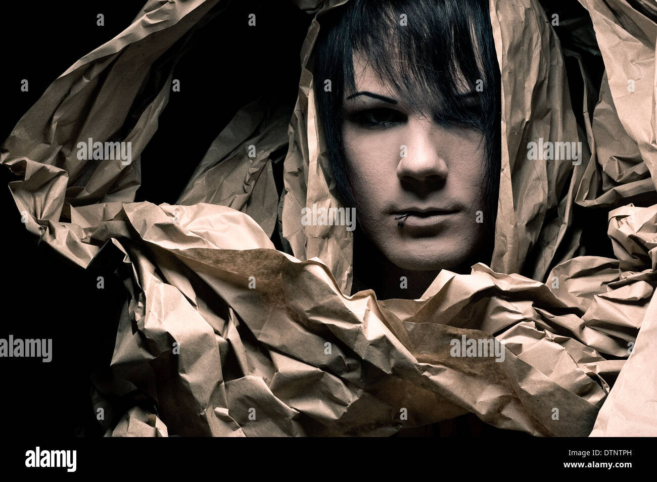 A male portrait, his face is wrapped with brown paper, a creative ...