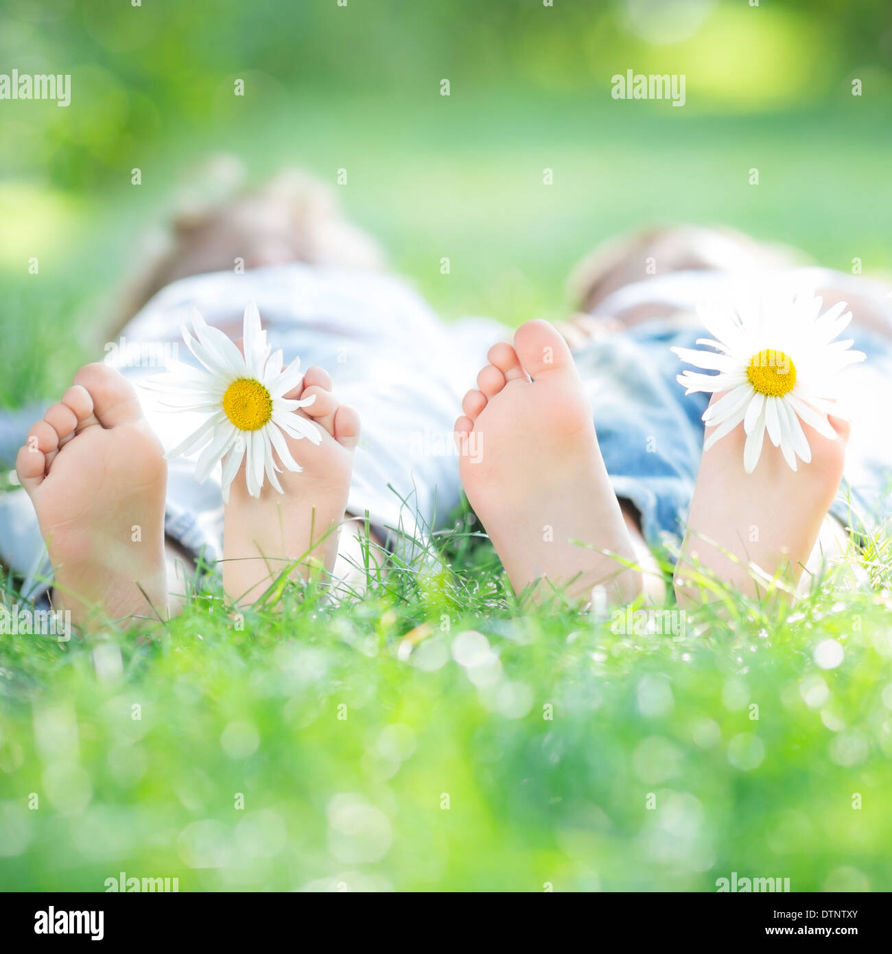 Boy lying on grass legs hi-res stock photography and images - Alamy