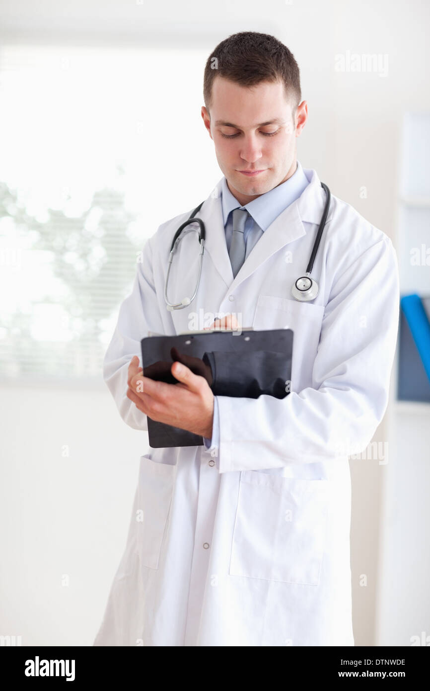 Doctor having a look at his notes Stock Photo - Alamy