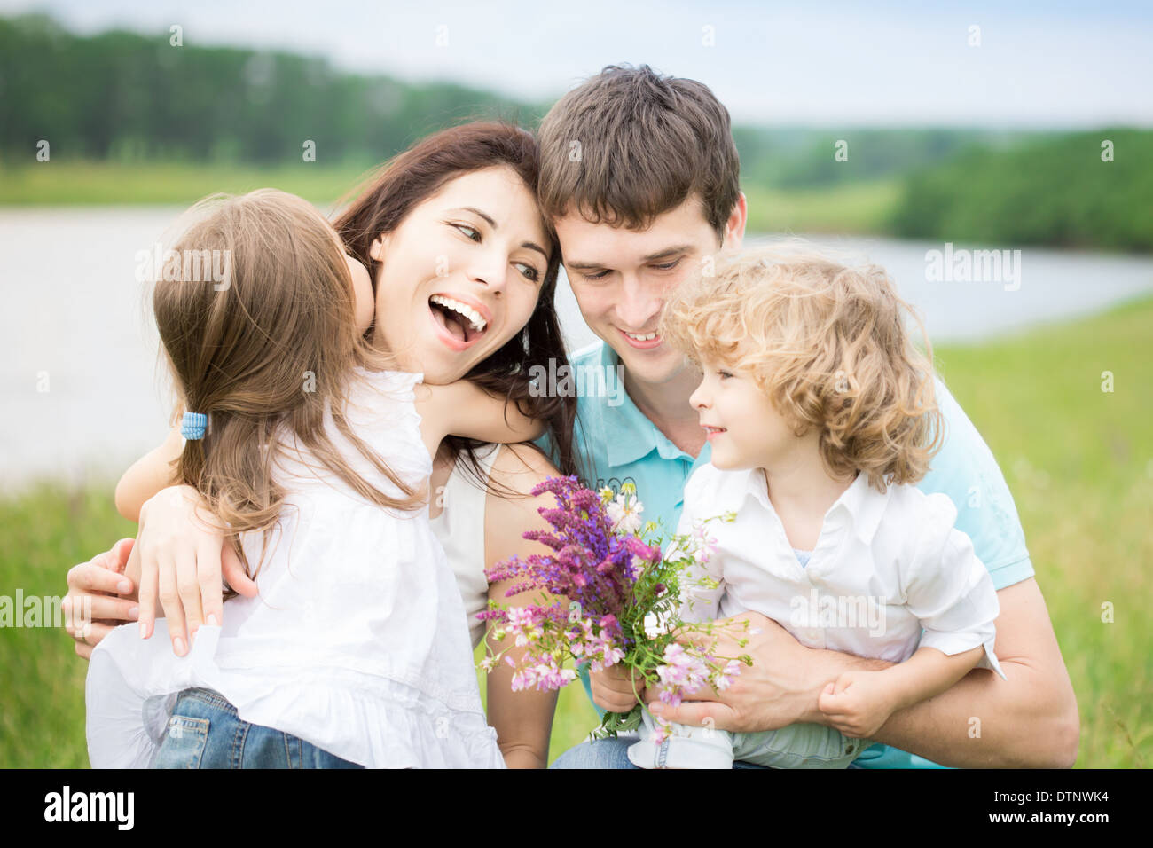 Happy family family in green hi-res stock photography and images - Alamy