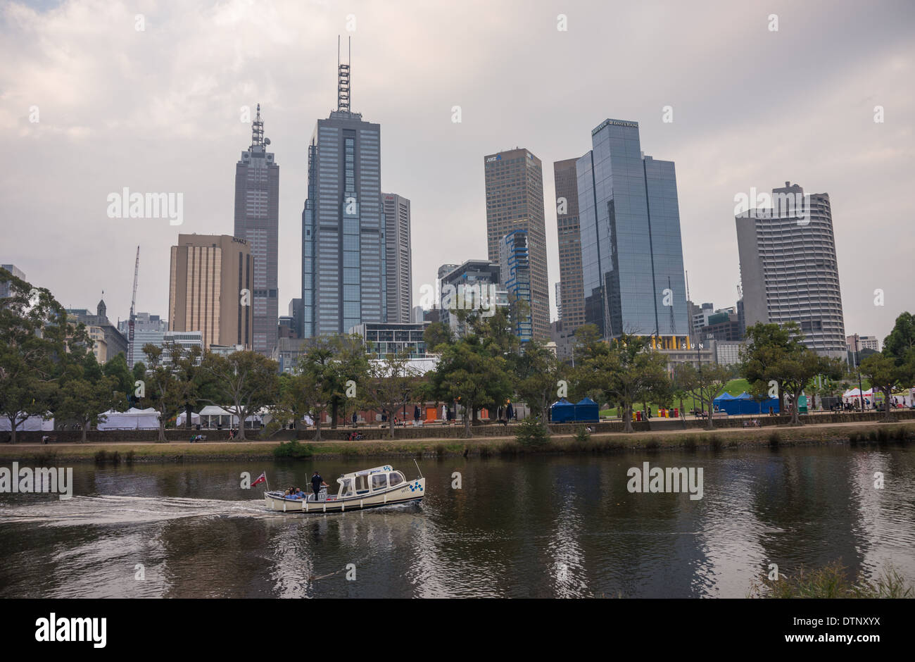 melbourne skyline with the yarra river in the foreground and a boat on ...