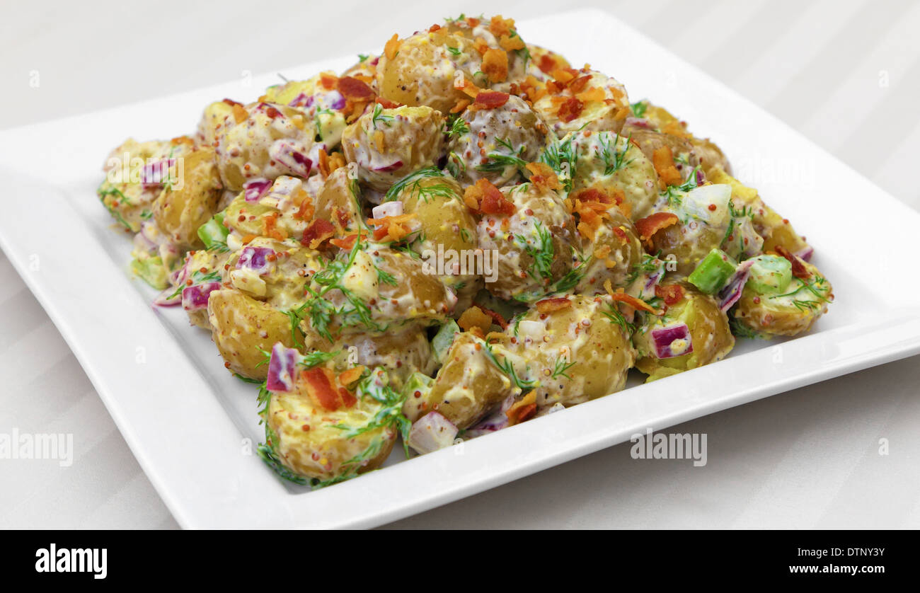 Potato salad served on a square plate Stock Photo - Alamy