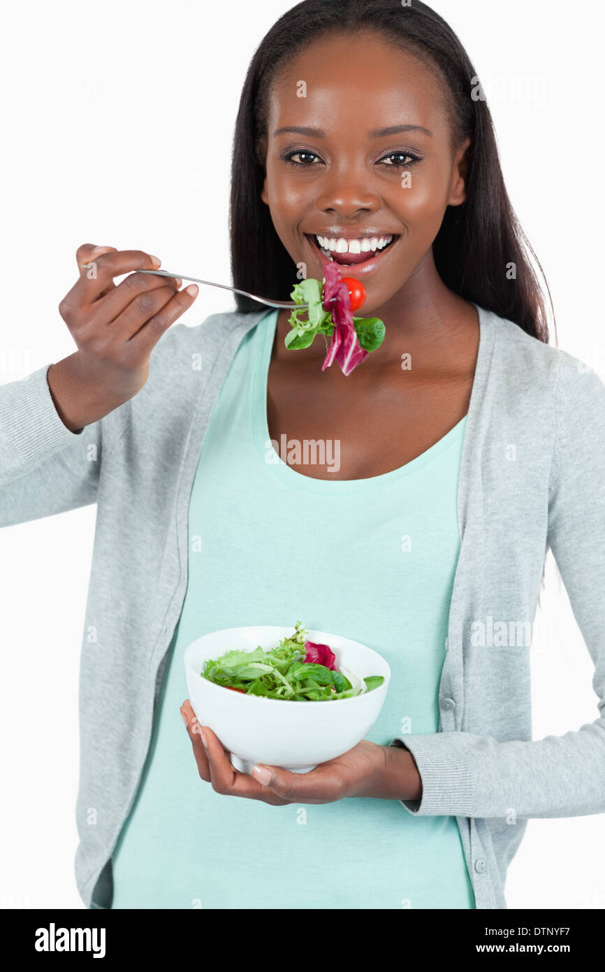 Happy smiling woman eating salad Stock Photo - Alamy
