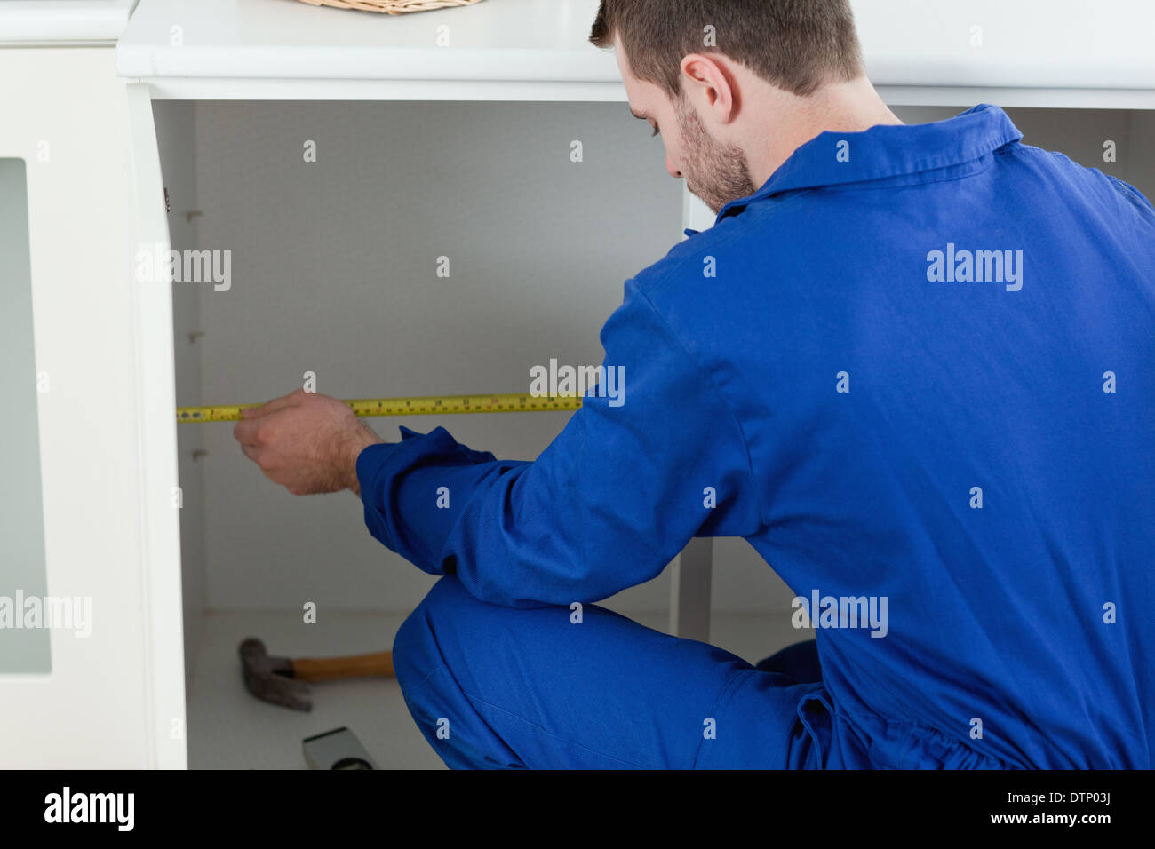 Focused repair man measuring something Stock Photo - Alamy