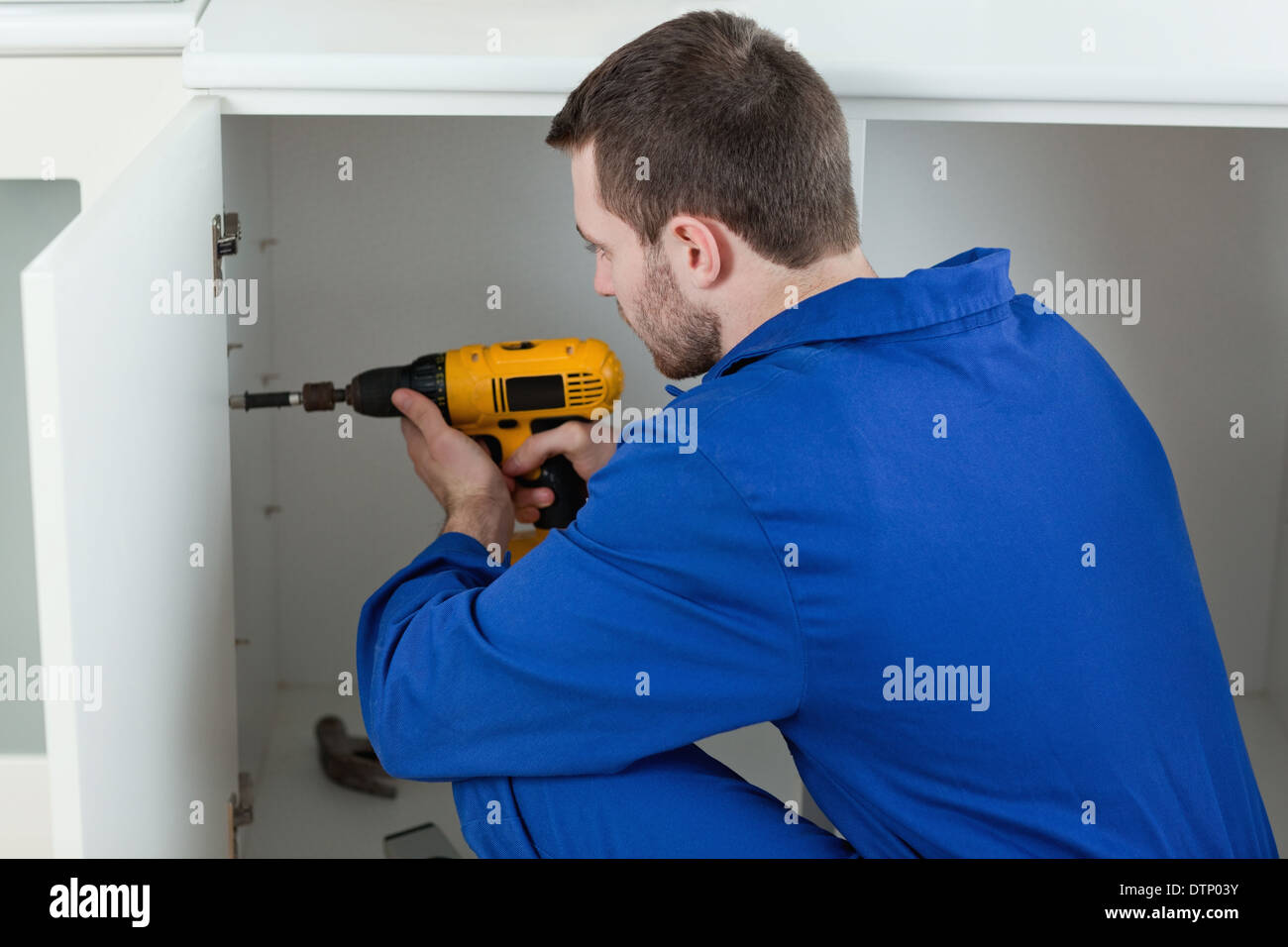 Handyman fixing a door Stock Photo - Alamy