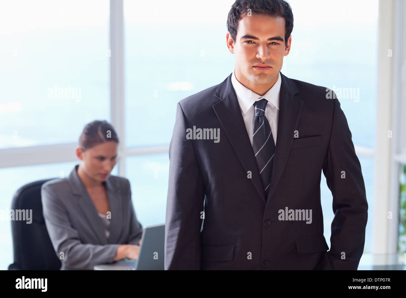 Businessman with his secretary behind him Stock Photo - Alamy