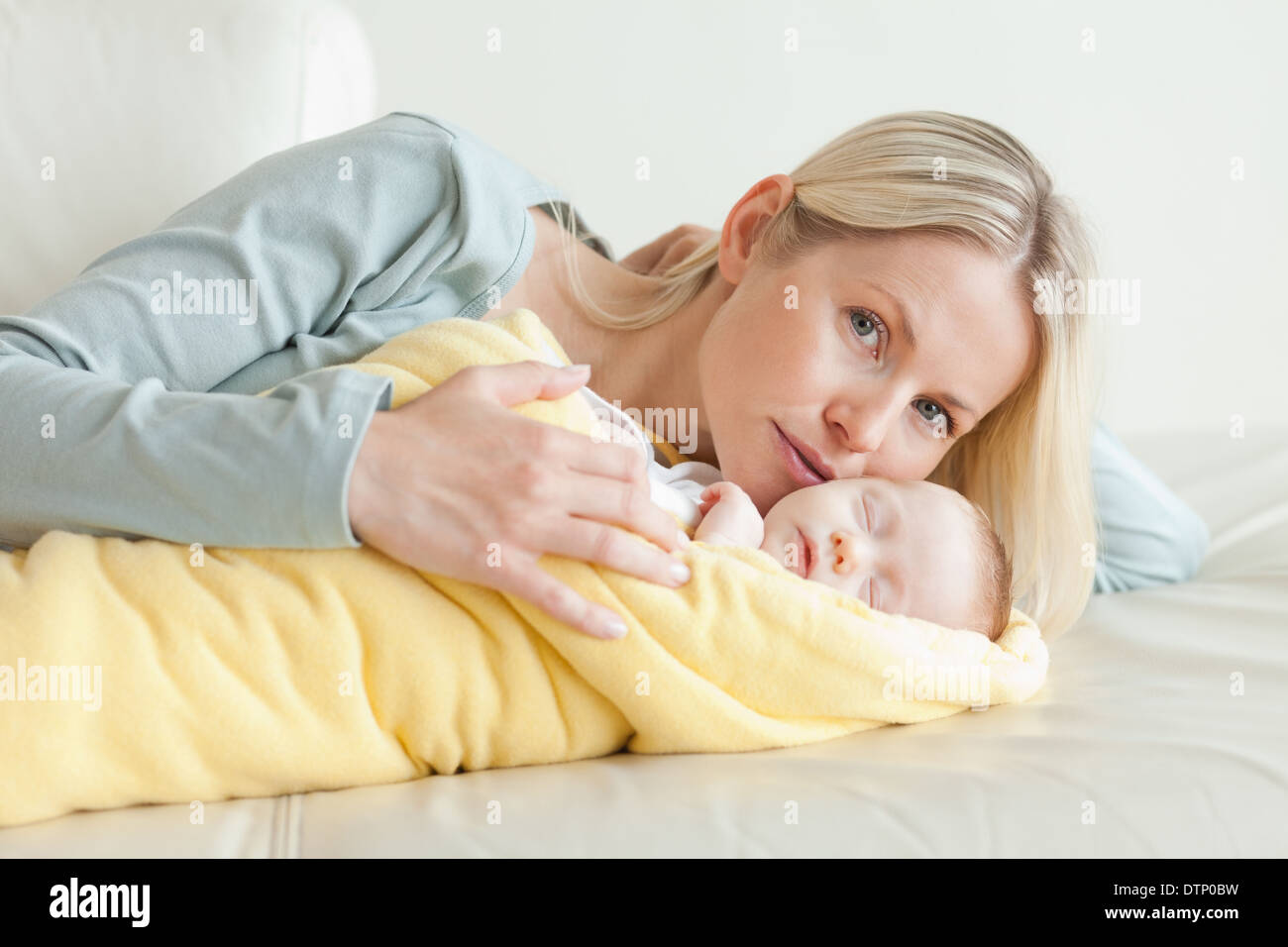 Mom relaxing next to her baby Stock Photo - Alamy