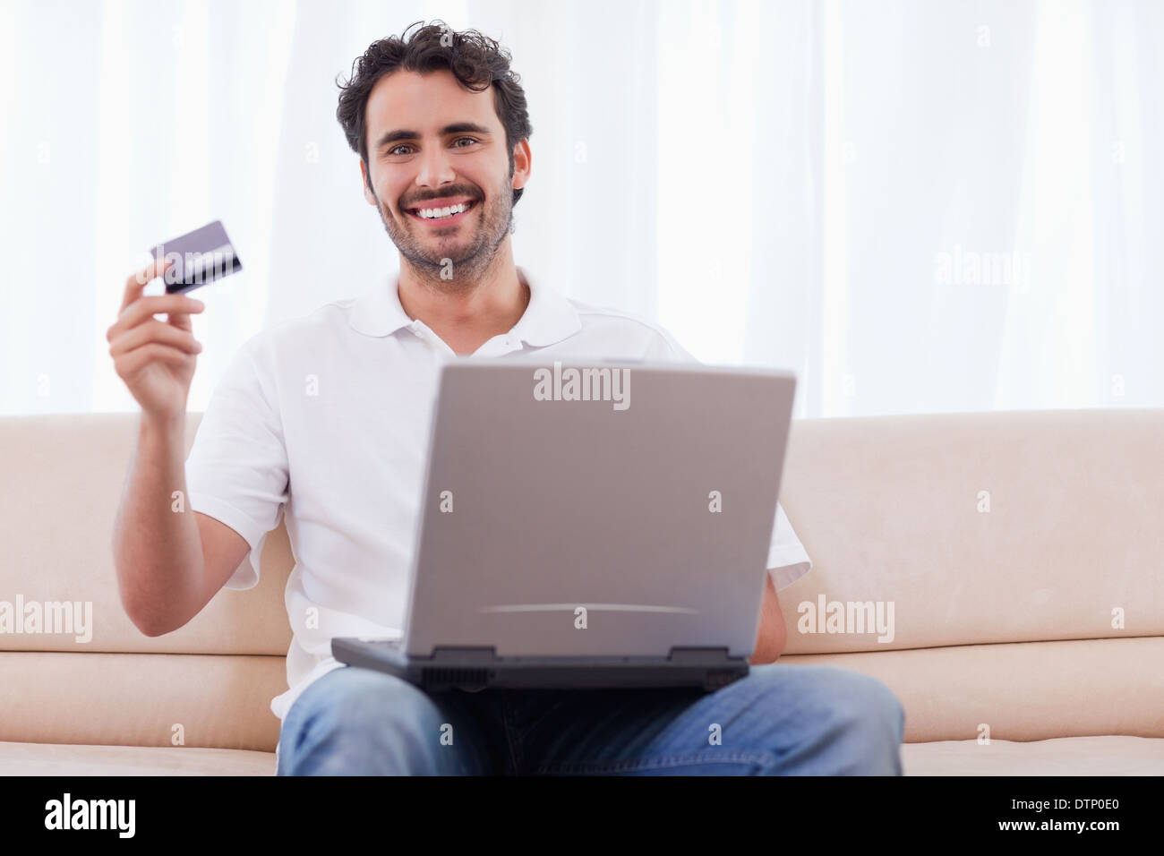 Happy man buying online Stock Photo - Alamy