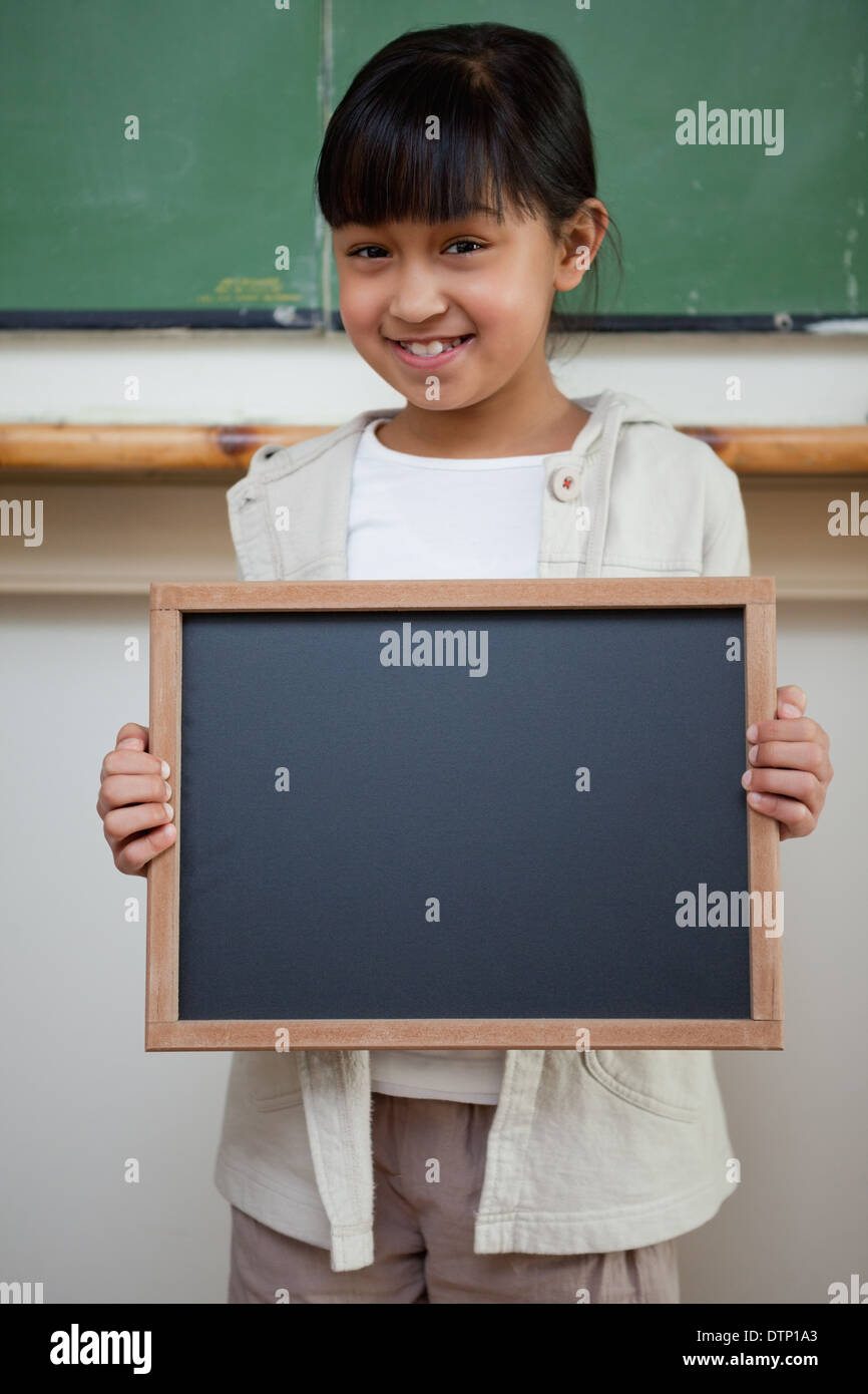 Portrait of a girl holding a school slate Stock Photo - Alamy
