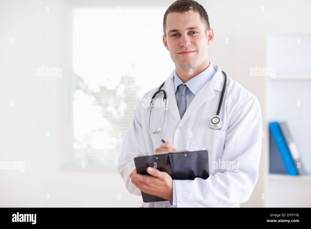 Young doctor taking notes Stock Photo - Alamy